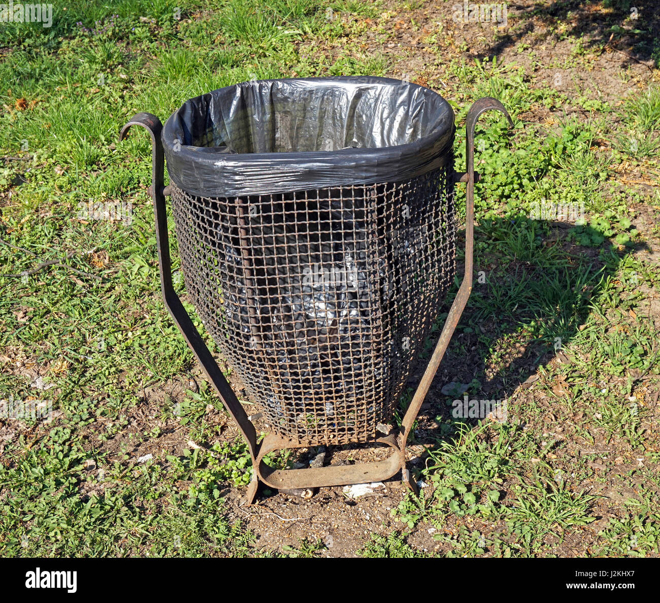 Trash can in the park in the city Stock Photo - Alamy