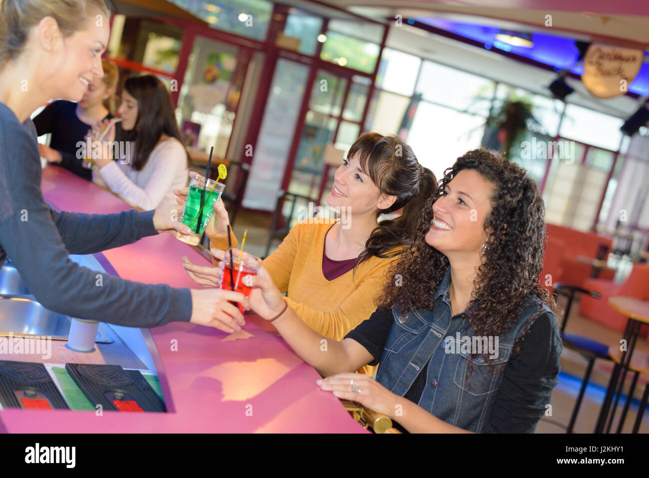 friends being served drinks in hotel bar Stock Photo - Alamy