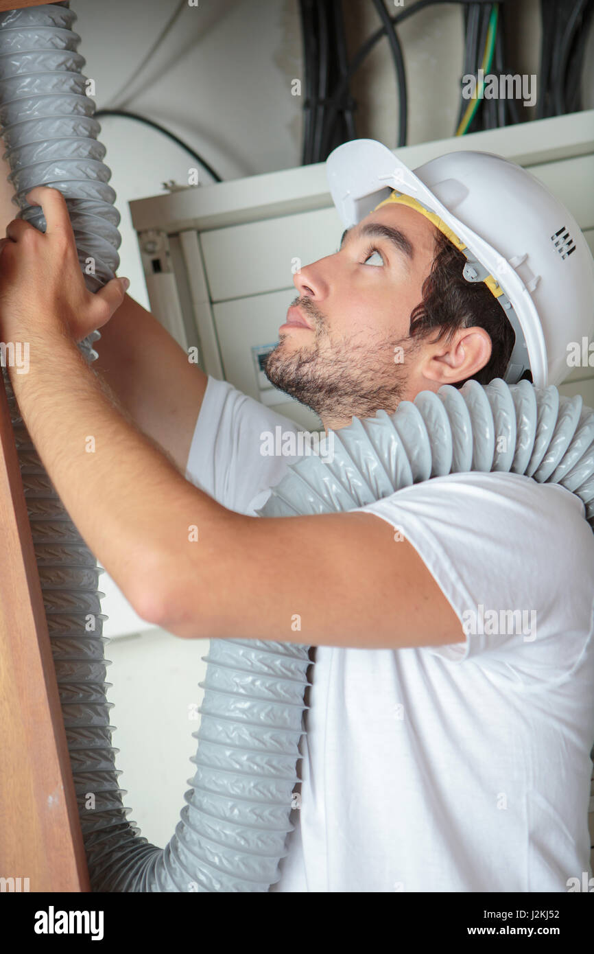 pipe fitter installing a pipe Stock Photo - Alamy