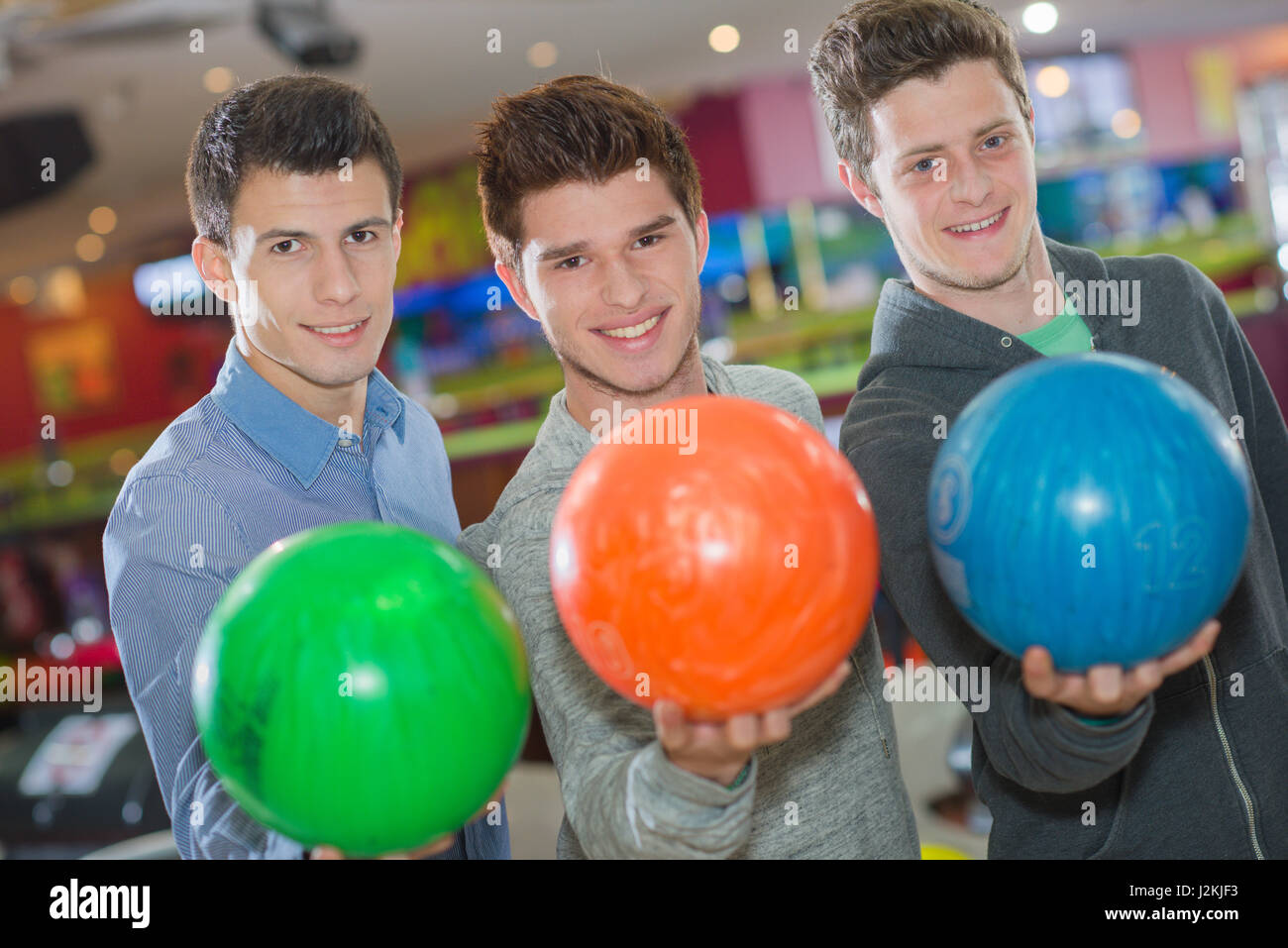 Three men holding bowling balls hi-res stock photography and images - Alamy
