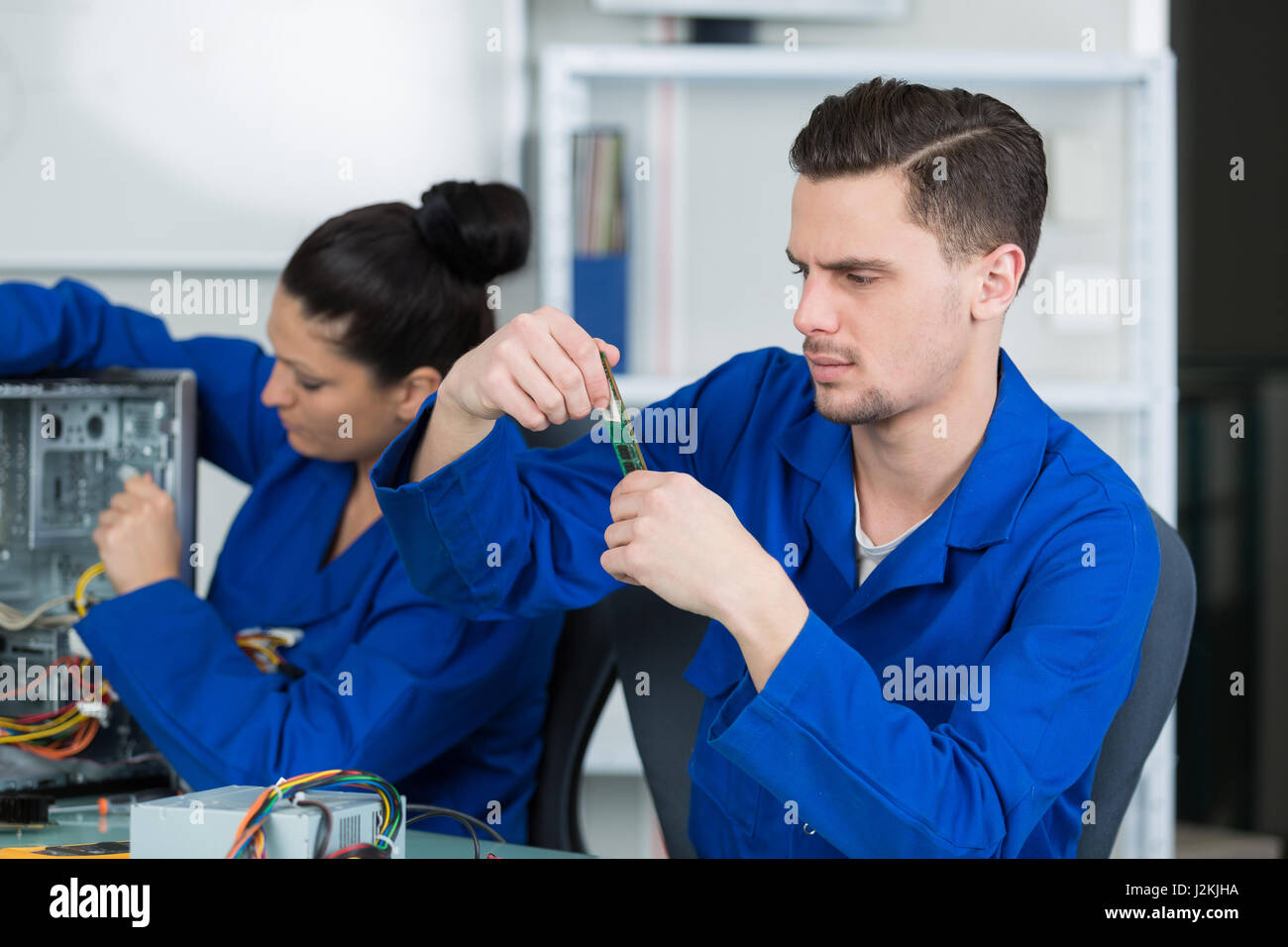 team of students examining and repairing computer parts Stock Photo - Alamy