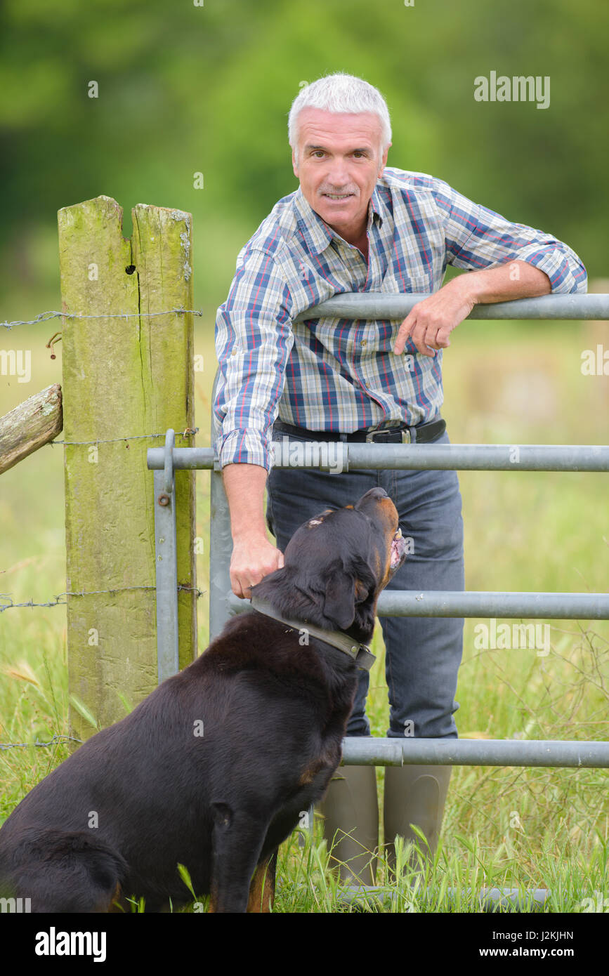 farmer in the field with a dog Stock Photo - Alamy