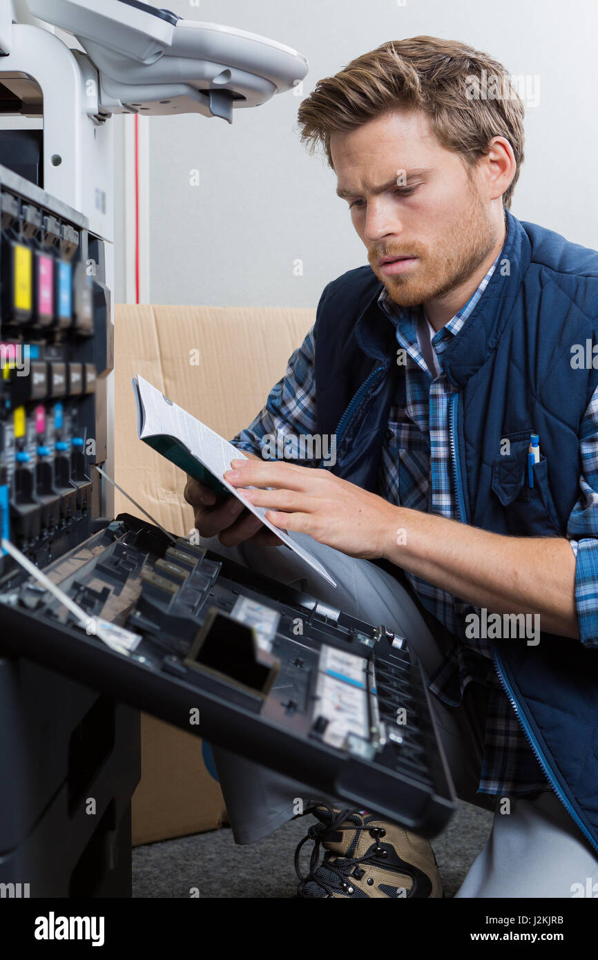 fixing an office printer Stock Photo - Alamy