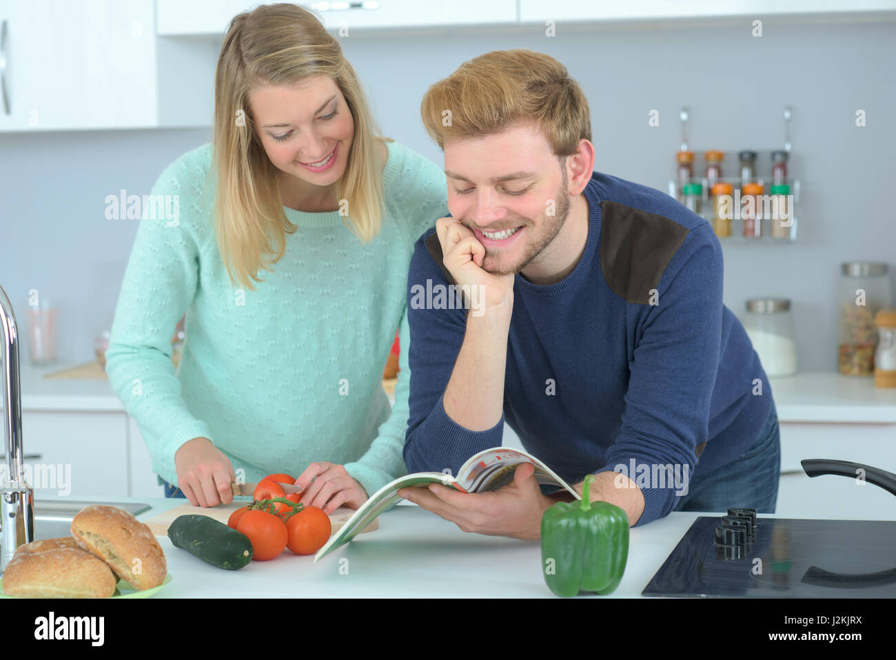 Couple following recipe from a magazine Stock Photo - Alamy