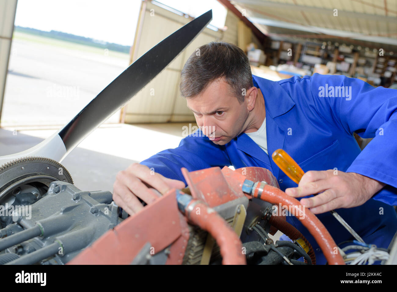 Mechanic working on aircraft Stock Photo - Alamy