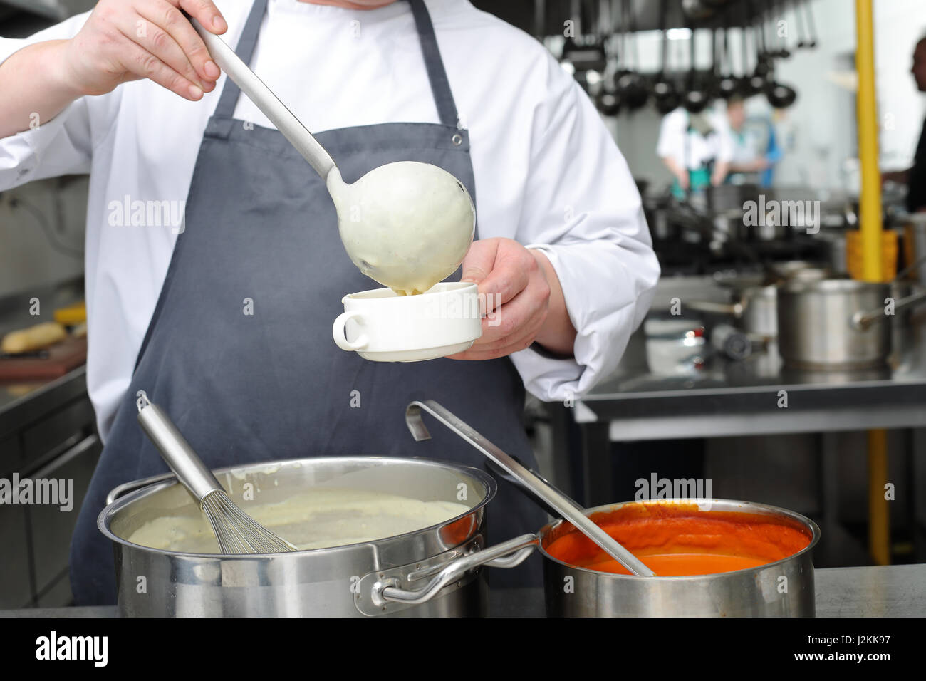 Chef in hotel or restaurant kitchen cooking Stock Photo - Alamy