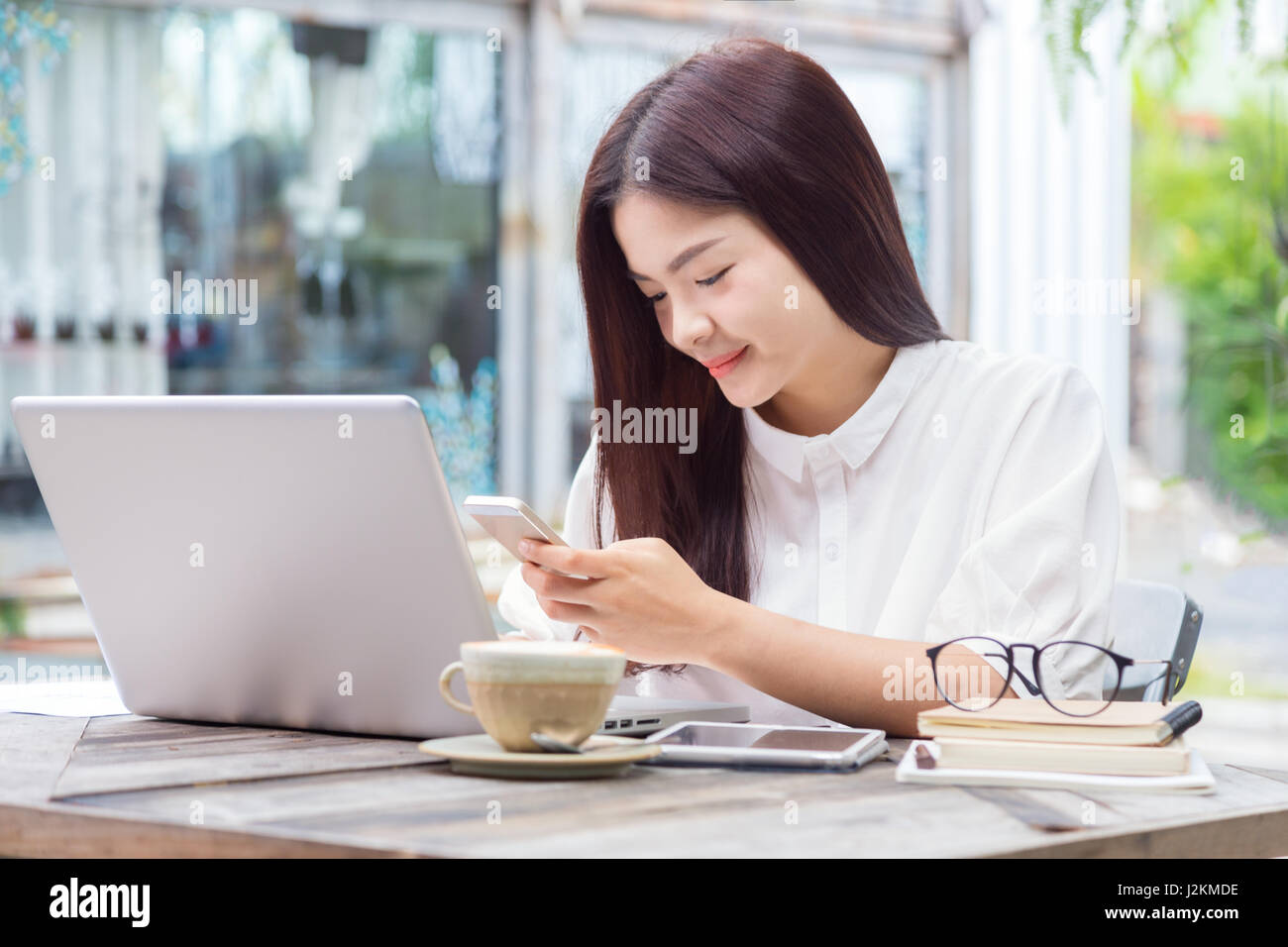 young casual asian woman using technology on her laptop computer and ...