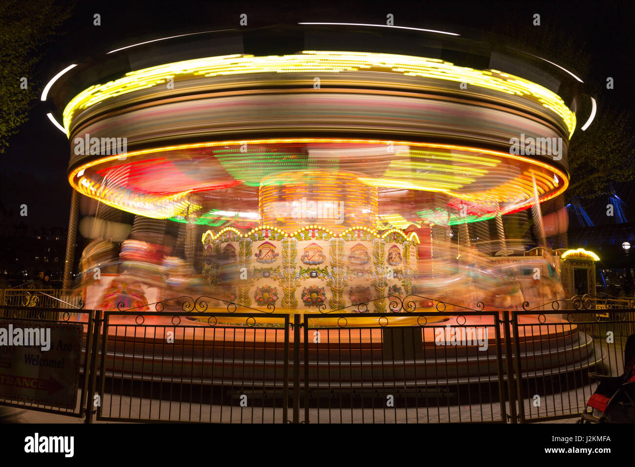 merry go round, carousel, in motion at night, showing colorful lighting ...