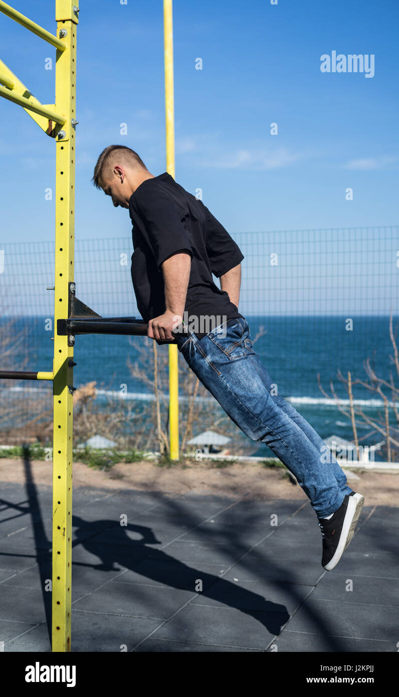 Young Athlete doing a Hand Stand On Parallel Bars In An Outdoor Gym ...