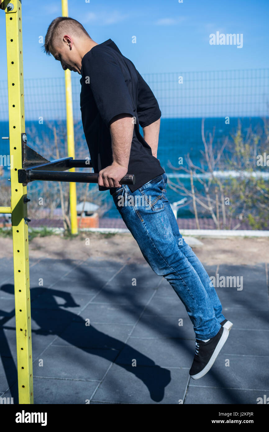 Young Athlete doing a Hand Stand On Parallel Bars In An Outdoor Gym ...
