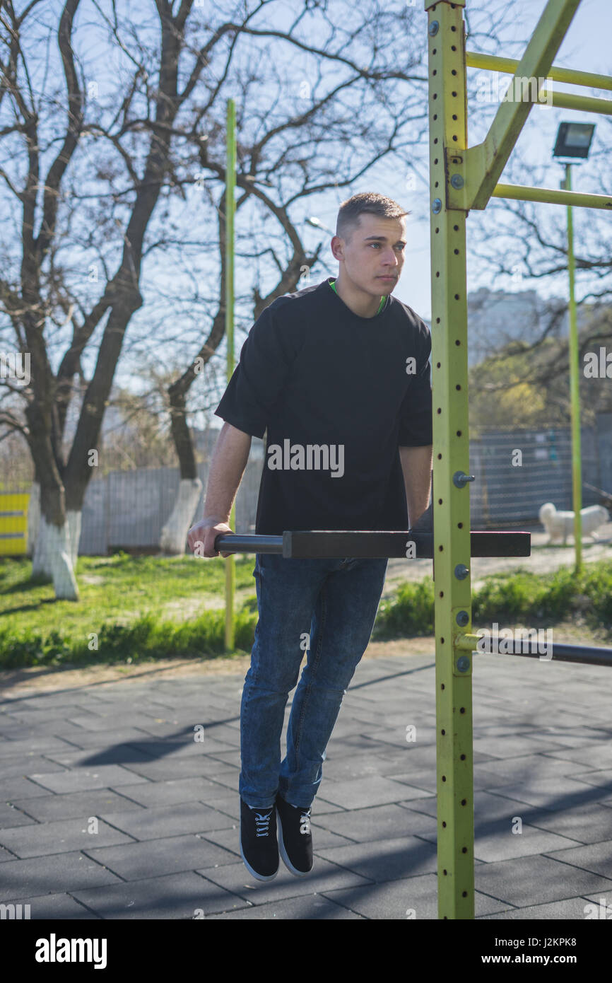 Young Athlete doing a Hand Stand On Parallel Bars In An Outdoor Gym ...