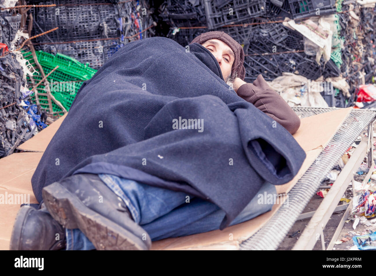 homeless man sleeps in the waste on a wire mesh of bed Stock Photo - Alamy