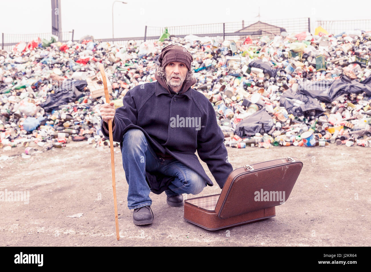 homeless collects alms from the suitcase Stock Photo - Alamy
