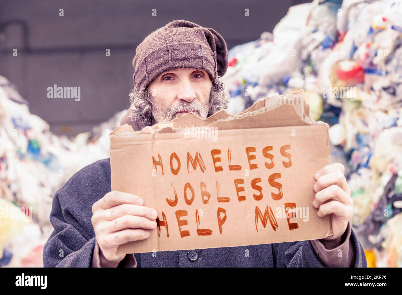 homeless show a help message written on a cardboard Stock Photo - Alamy