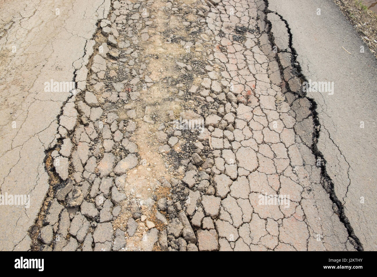 Asphalt street cracked and broken Stock Photo - Alamy