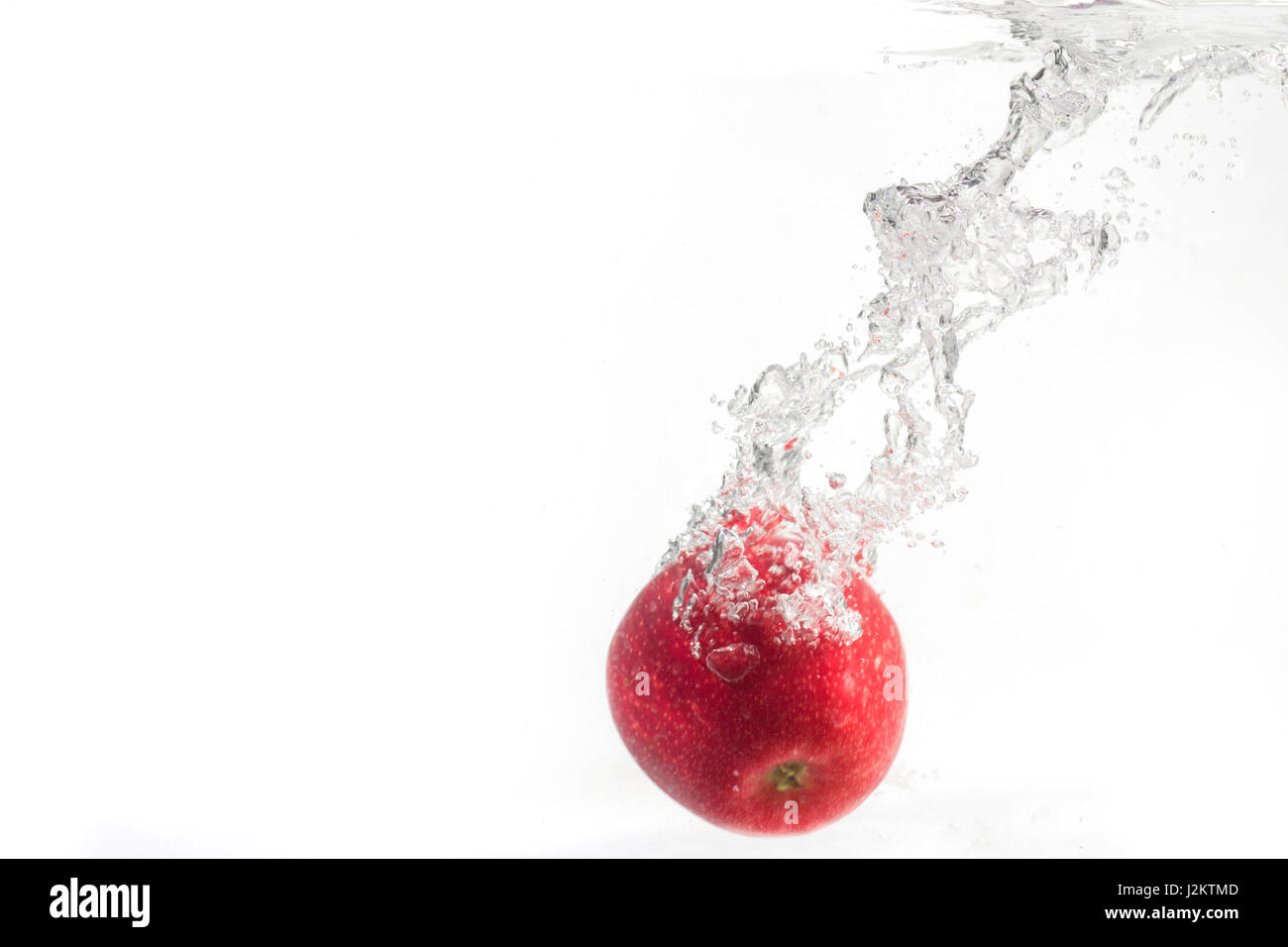 red apple splash water Stock Photo - Alamy