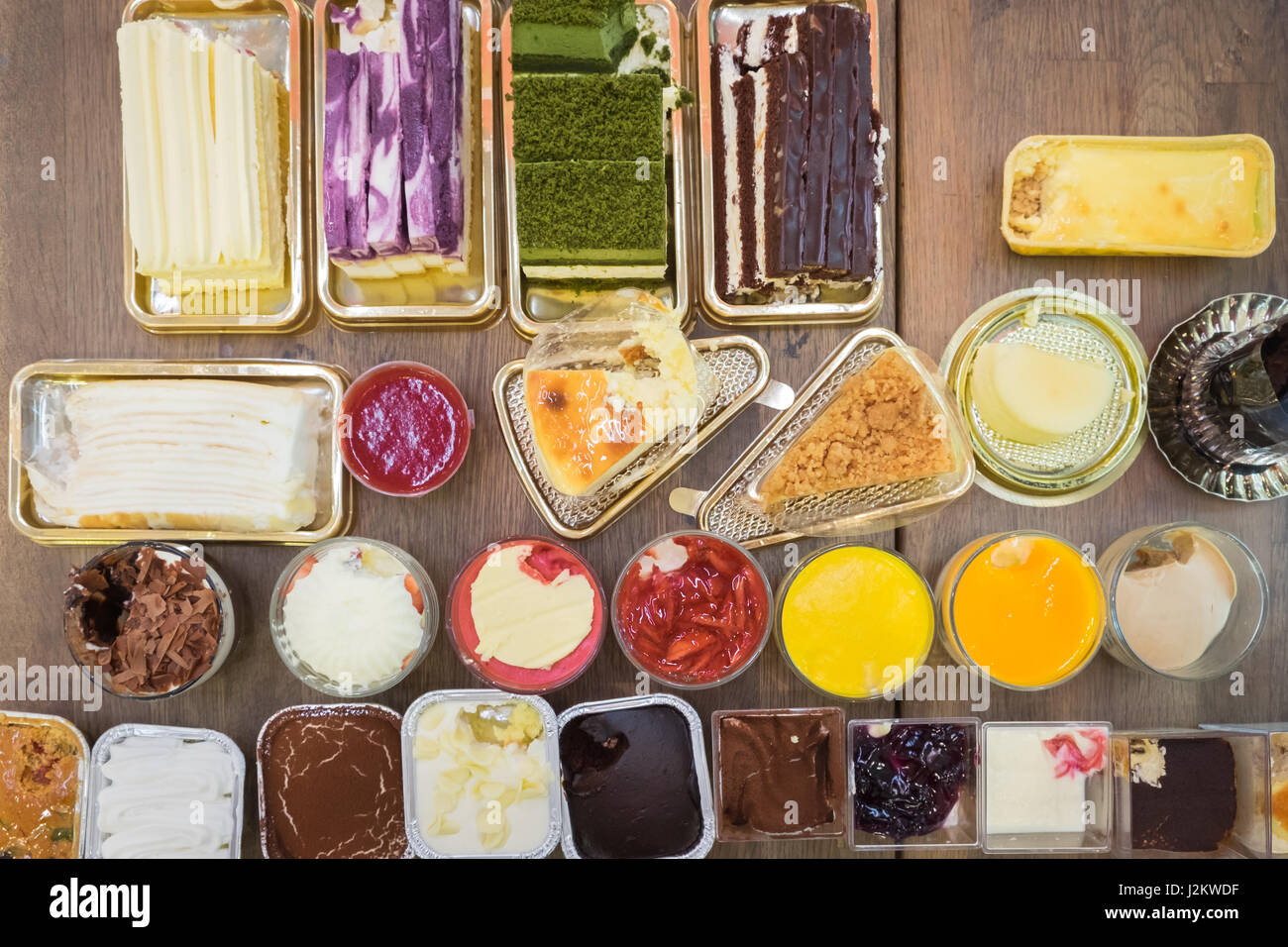 Enjoying eating cake. Top view of group of cake on the rustic wooden ...