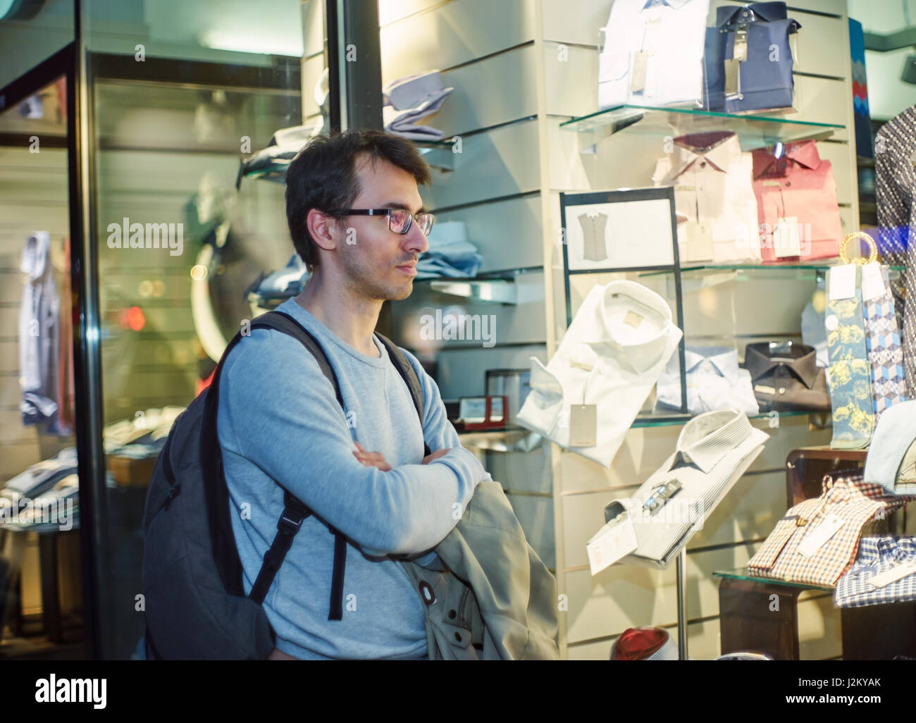 A young man in front of clothing store Stock Photo - Alamy