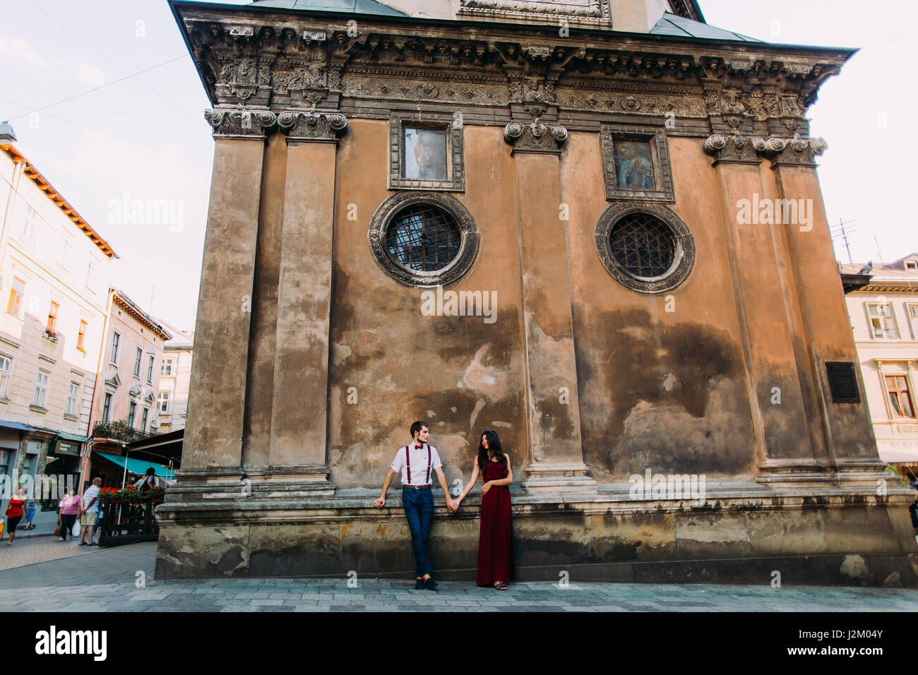 Beautiful luxury dressed stylish couple on a background of Lviv Roman ...