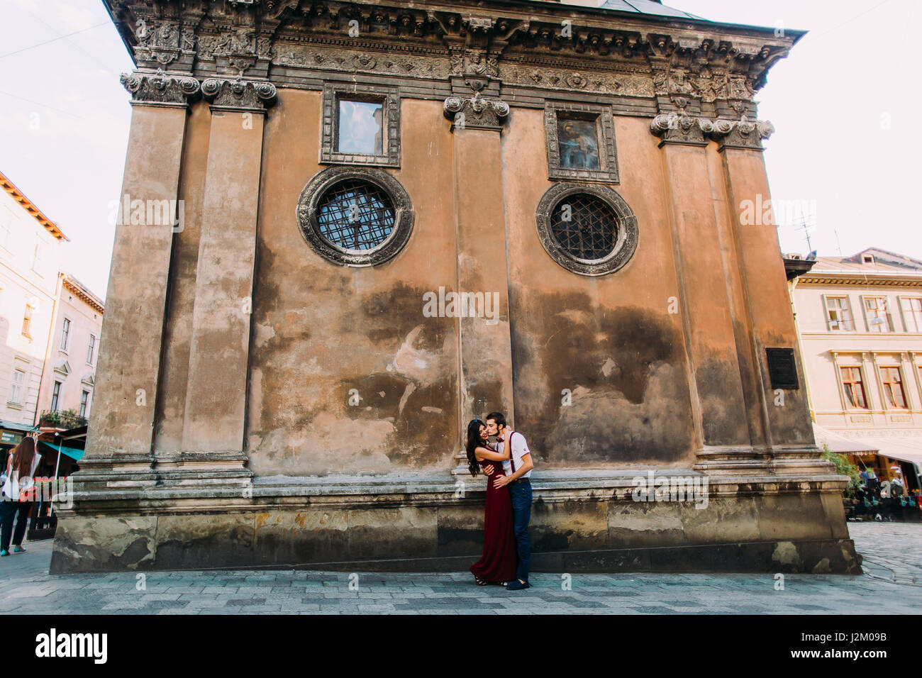 Beautiful luxury dressed stylish couple on a background of Lviv Roman ...