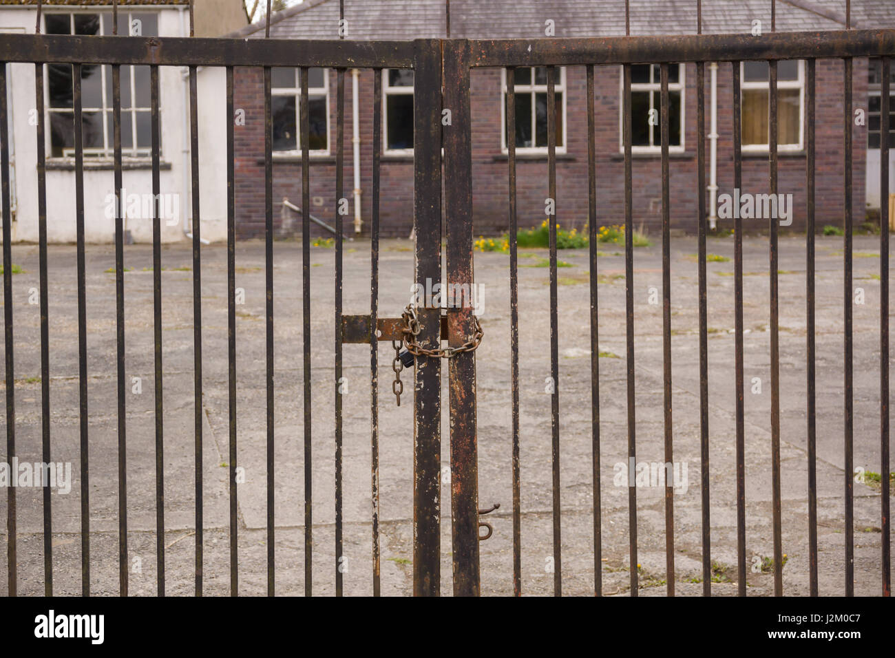 Set of locked security gates at a derelict or abandoned industrial or ...