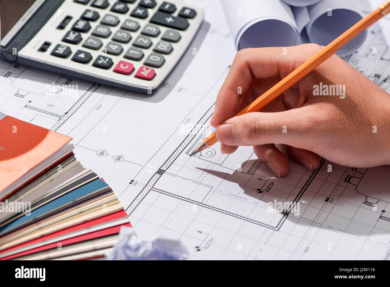 Working on blueprints. Construction project with tools and notebook ...