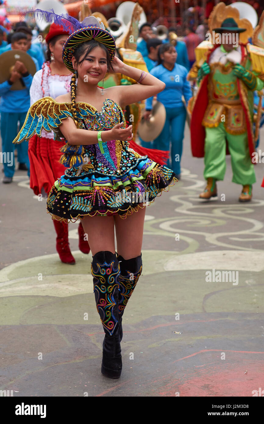 Morenada dance group in colourful outfits parading through the mining ...