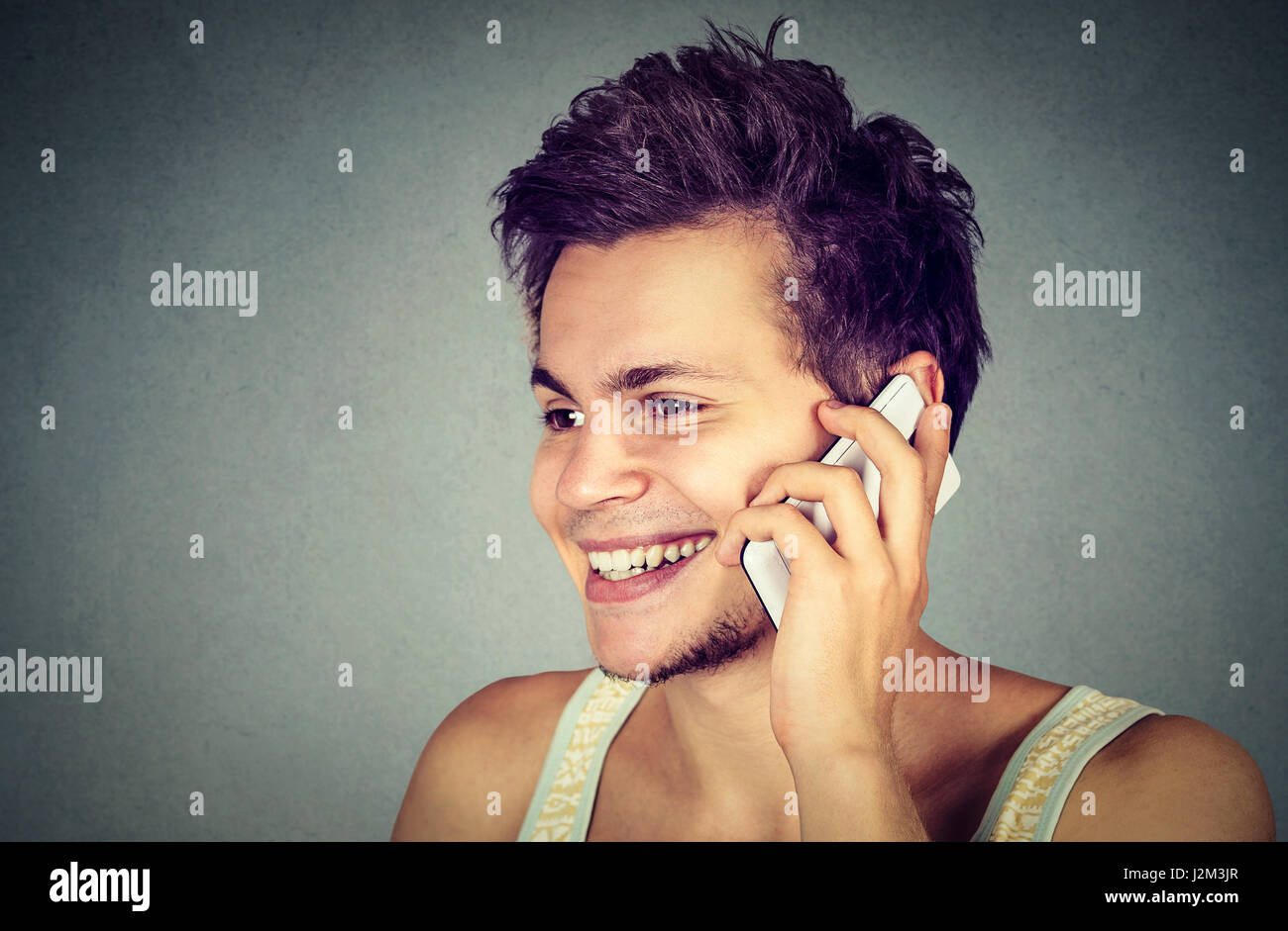 Man talking on mobile phone smiling Stock Photo - Alamy