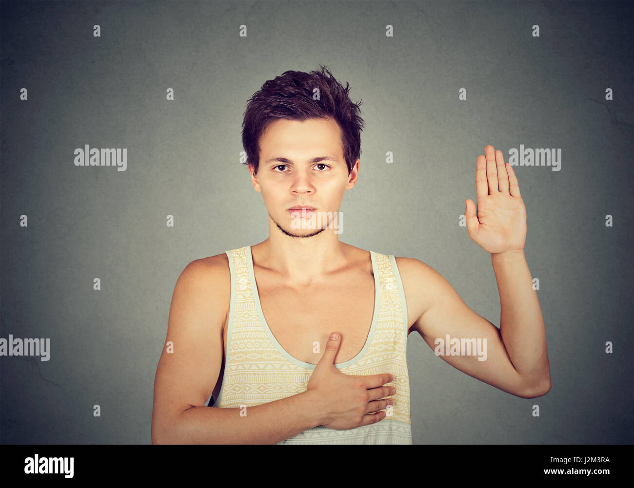 Young serious man making a promise Stock Photo - Alamy