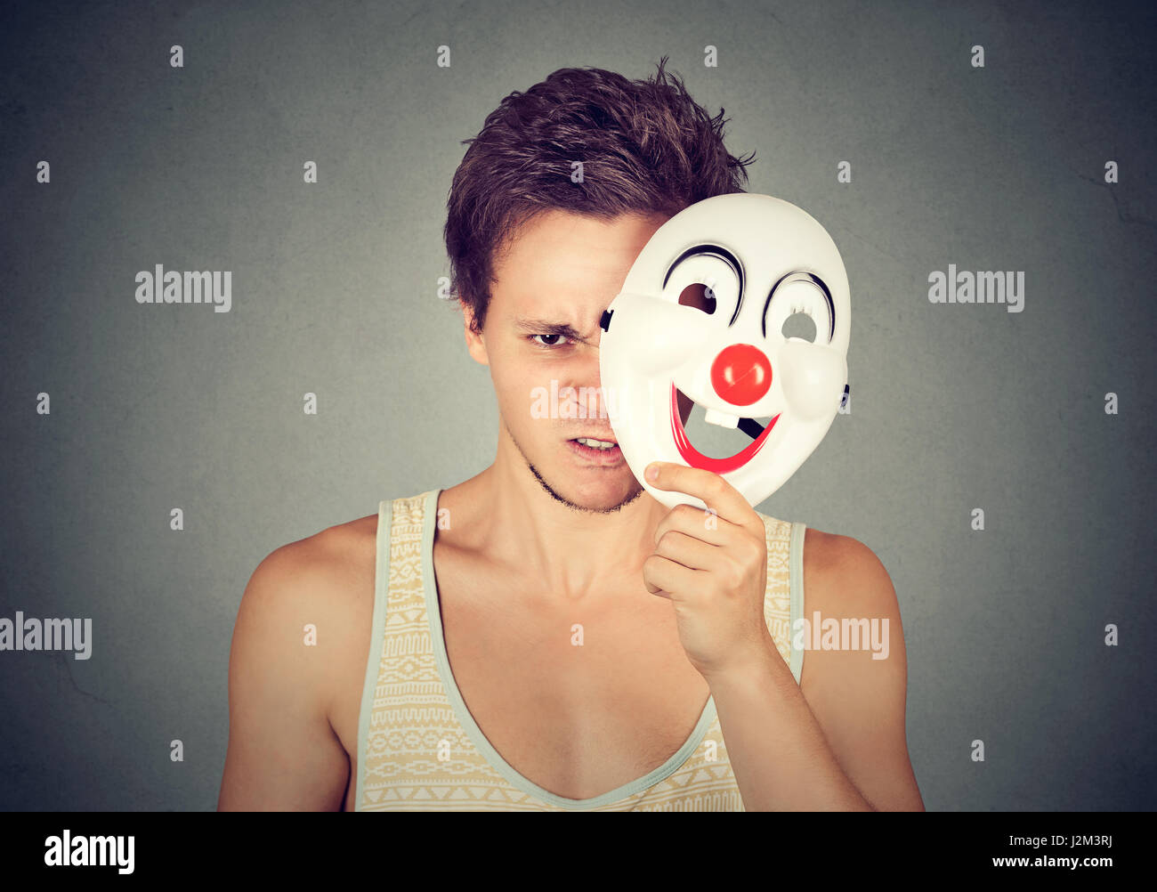 Upset frustrated angry man hiding behind happy face Stock Photo - Alamy