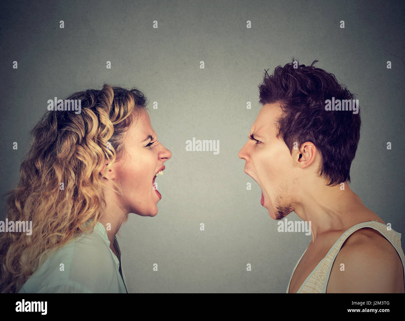 Angry young couple screaming face to face Stock Photo - Alamy