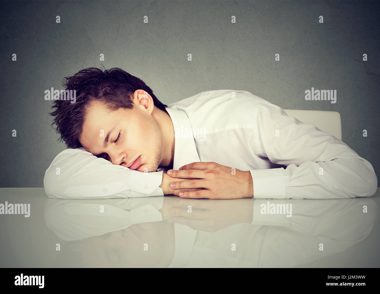 Man sleeping on a desk office table Stock Photo - Alamy