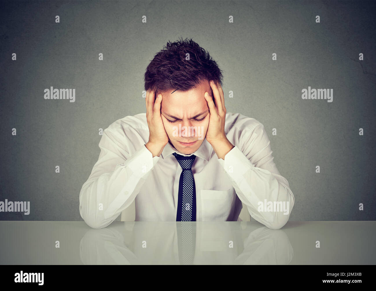 Man at table unhappy hi-res stock photography and images - Alamy