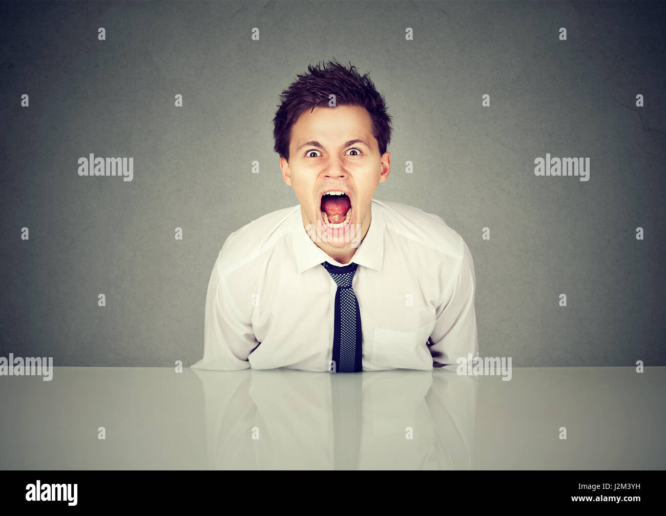 Angry young business man screaming Stock Photo - Alamy Angry young business man screaming Stock Photo - Alamy