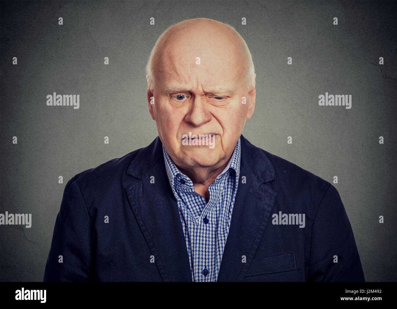 Elderly sad skeptical man looking down Stock Photo - Alamy