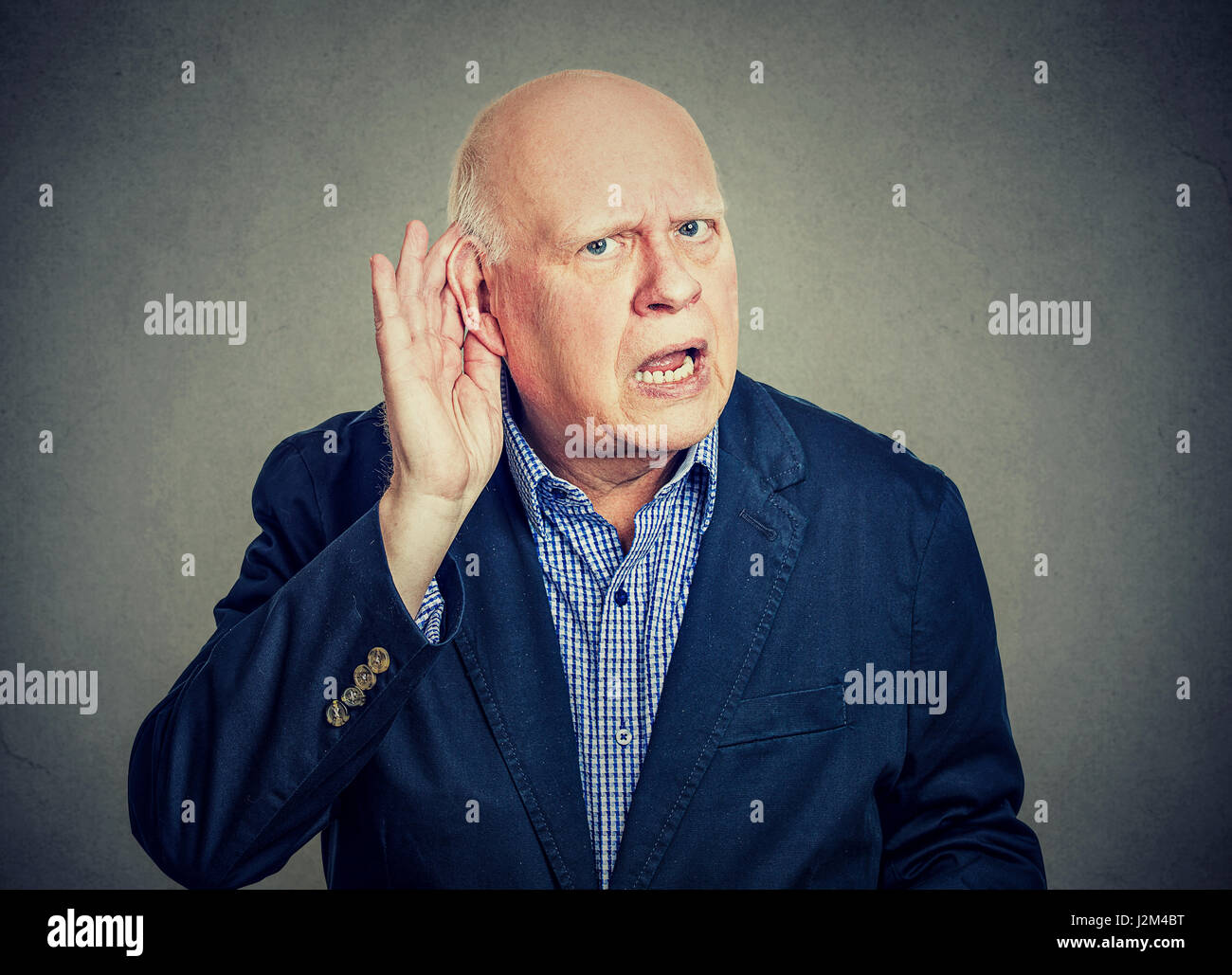 Elderly man holds his hand near ear and listening Stock Photo - Alamy
