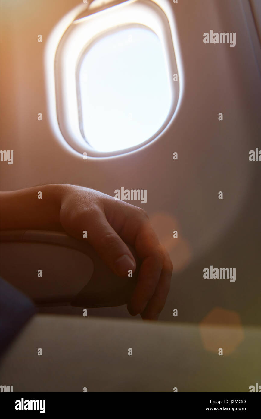Airplane passenger hand on sit handle with window background Stock ...