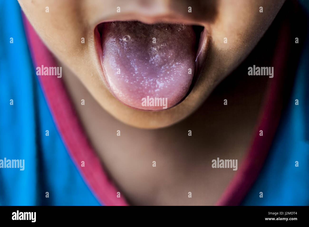 A small baby boy showing his tongue Stock Photo - Alamy