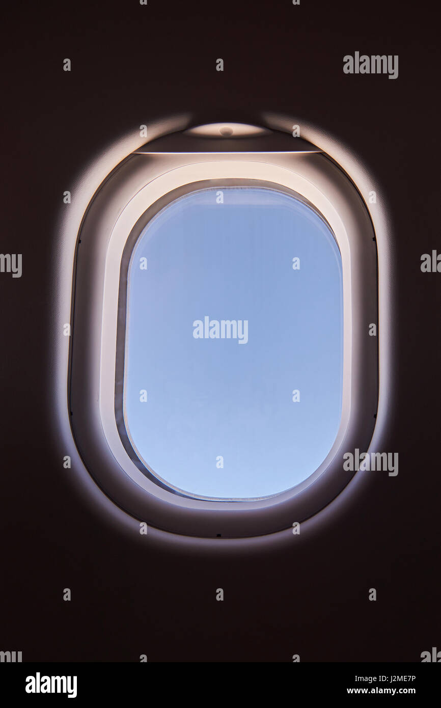 Blue sky in airplane window. One plane window close-up Stock Photo - Alamy
