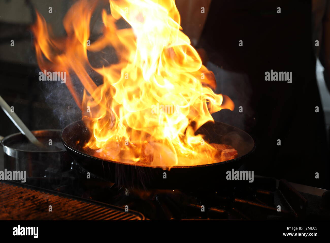 Chef in hotel or restaurant kitchen cooking Stock Photo - Alamy