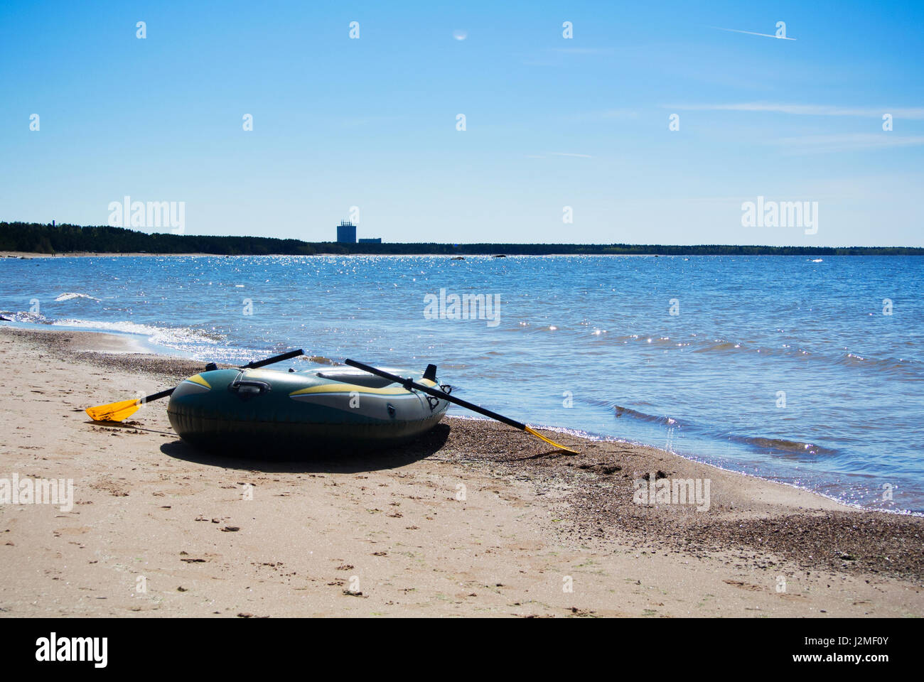 An inflatable boat at early spring morning on the coast of Baltic sea ...
