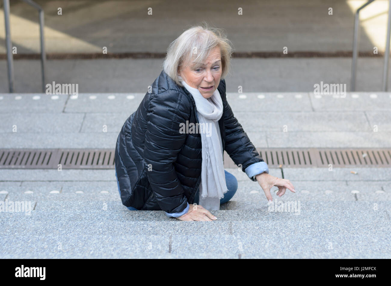 Helpless senior woman falling down steps and looking irritated Stock ...