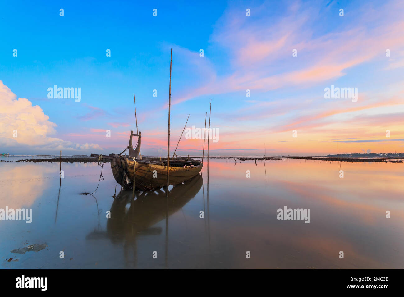 Wrecked fishing boat at sea with sunset Stock Photo - Alamy