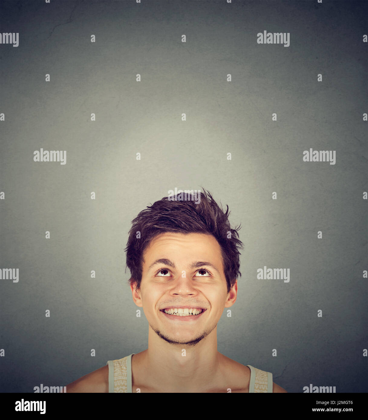 Portrait handsome smiling young man looking up Stock Photo - Alamy