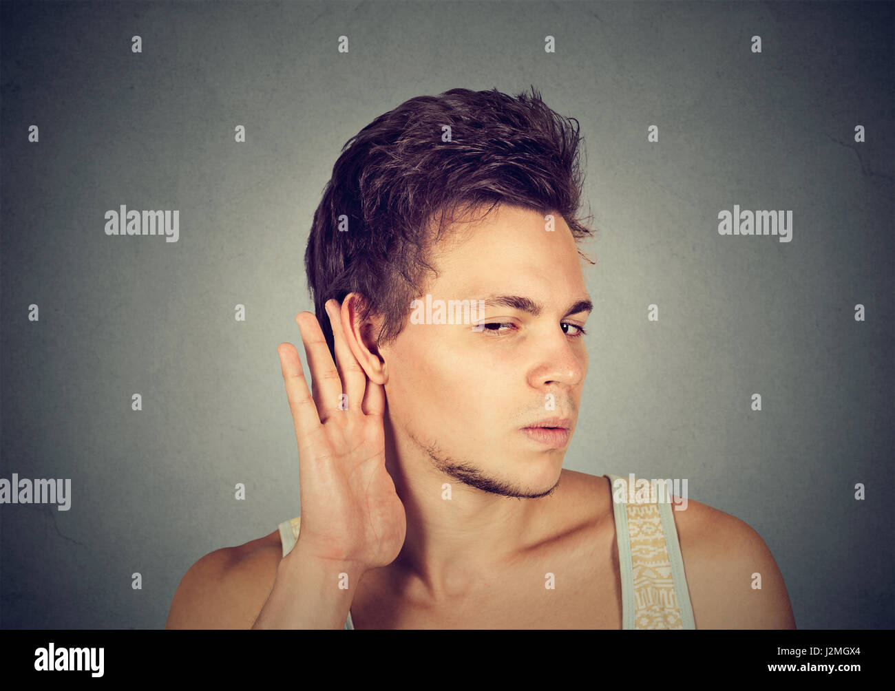 Closeup portrait a man placing hand on ear listening carefully to ...