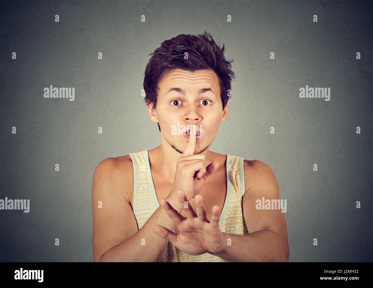 young handsome man giving Shhhh quiet, silence, secret gesture isolated ...