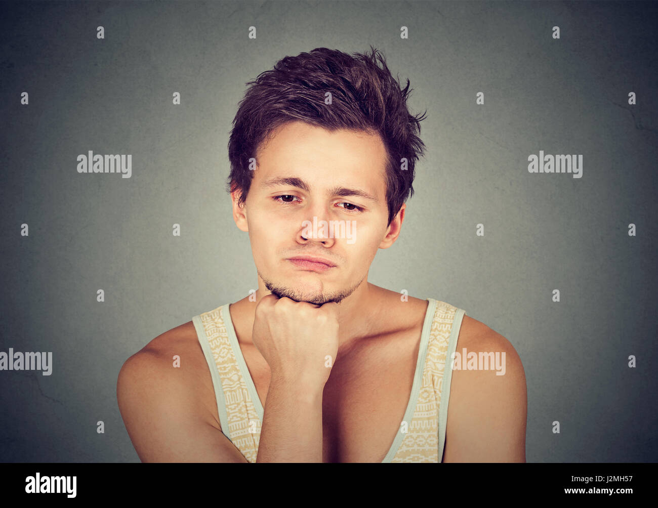 Sad lonely young man looking down has no energy motivation in life ...