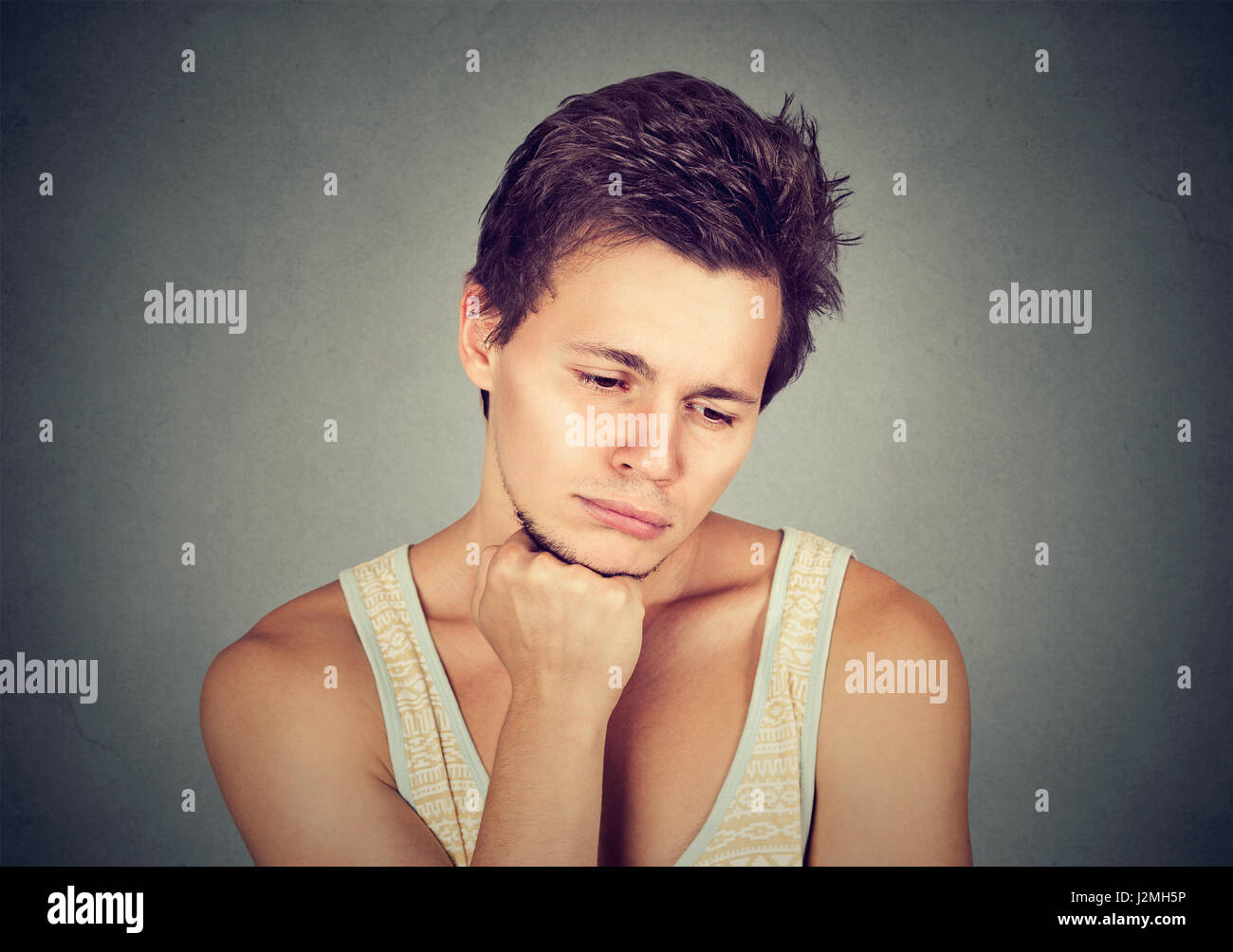 Sad lonely young man looking down has no energy motivation in life ...