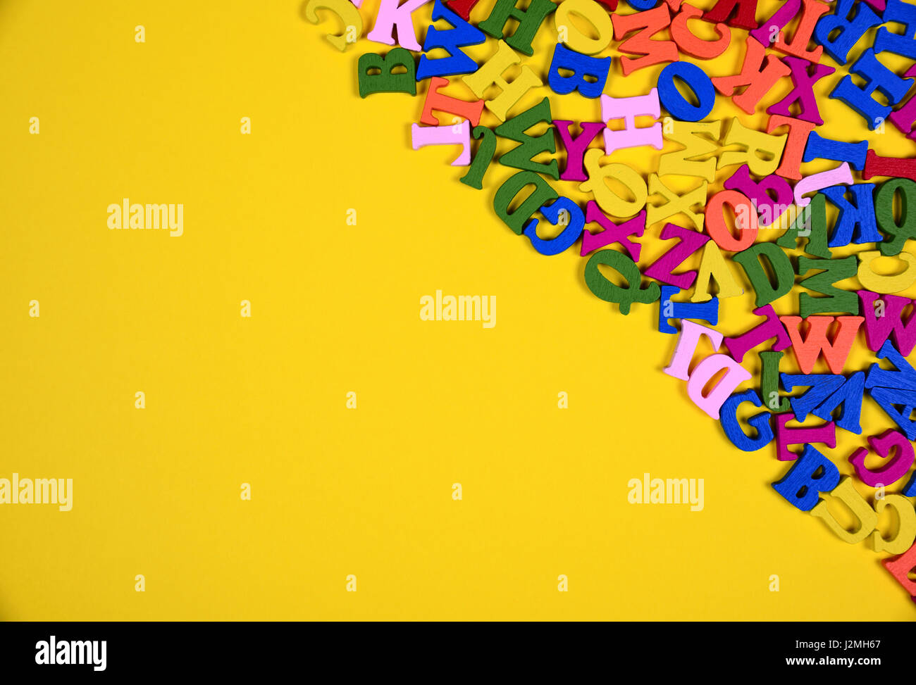 Multicolored wooden letters of the English alphabet are lined with an ...