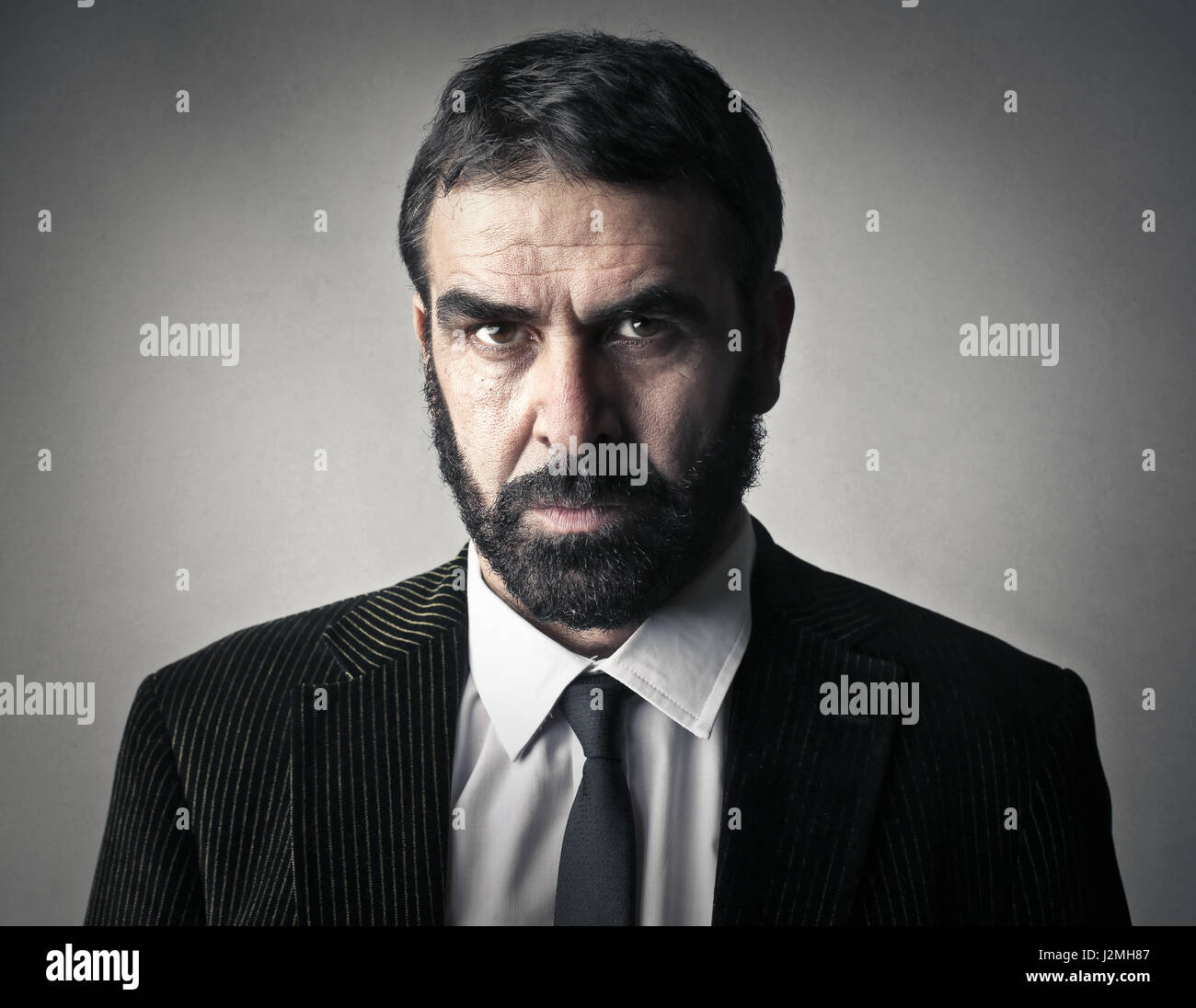 Bearded businessman making serious face Stock Photo - Alamy